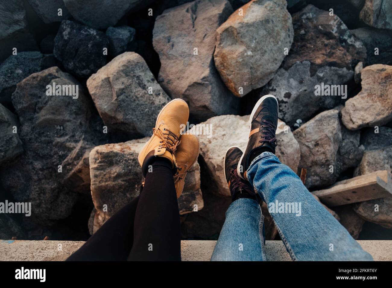 Feet of a couple on big stones one on another Stock Photo - Alamy