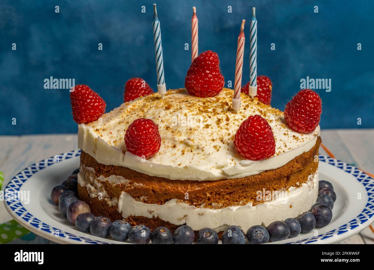 birthday cake with candles and streamer Stock Photo - Alamy