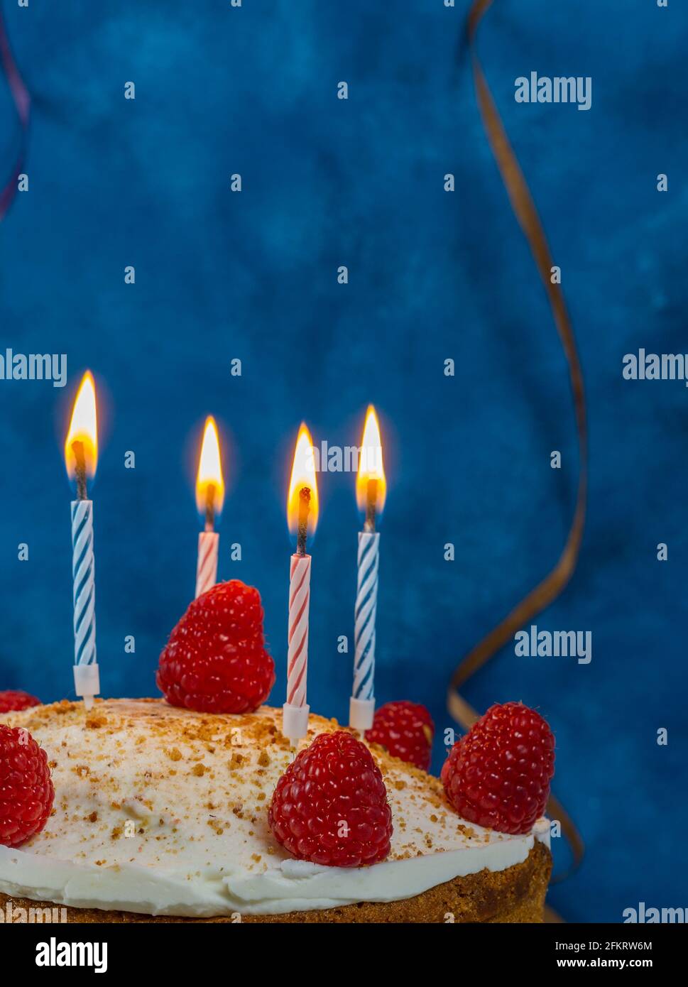 birthday cake with candles and streamer Stock Photo - Alamy
