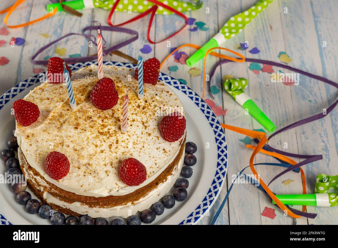birthday cake with candles and streamer Stock Photo - Alamy