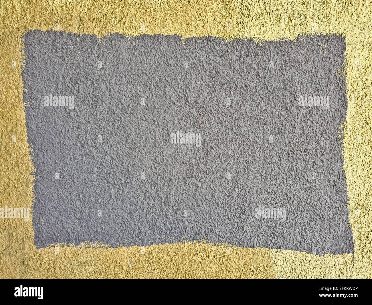 textured colored facing plaster of the street wall of the building ...