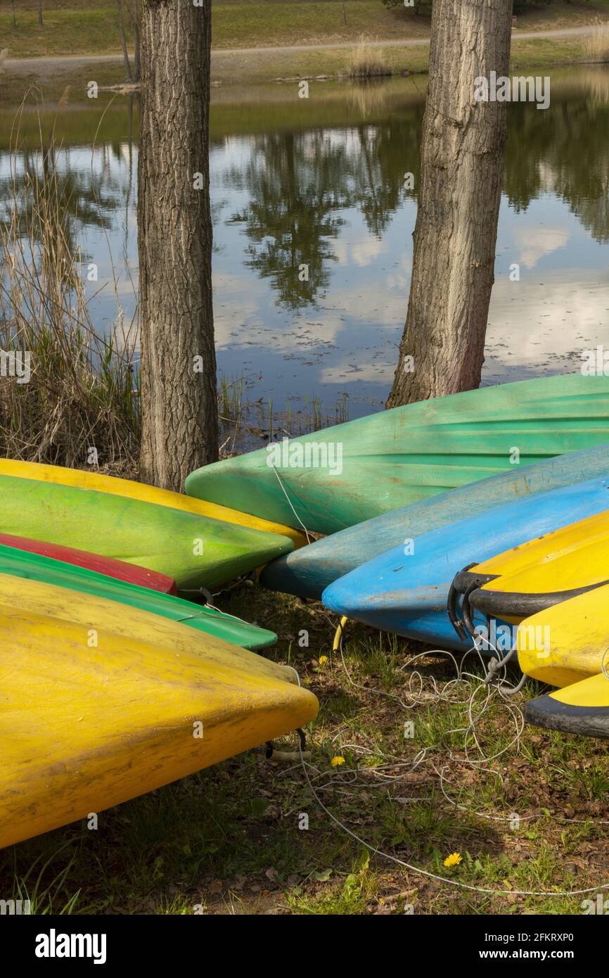 Vertical shot of colorful canoes on the Allier river coast in Auvergne ...