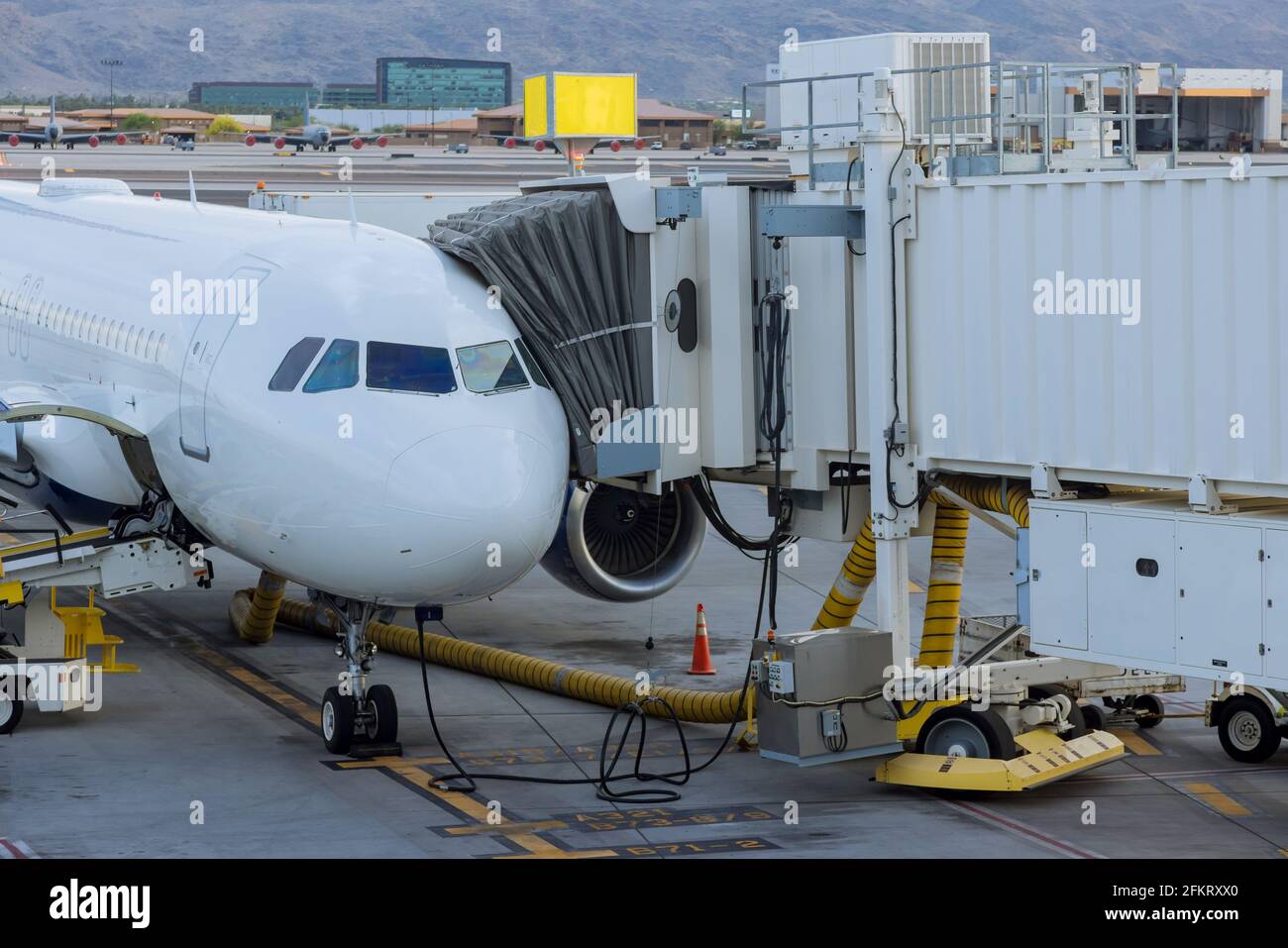 Aircraft at boarding bridge jetway connected to the airplane for ...