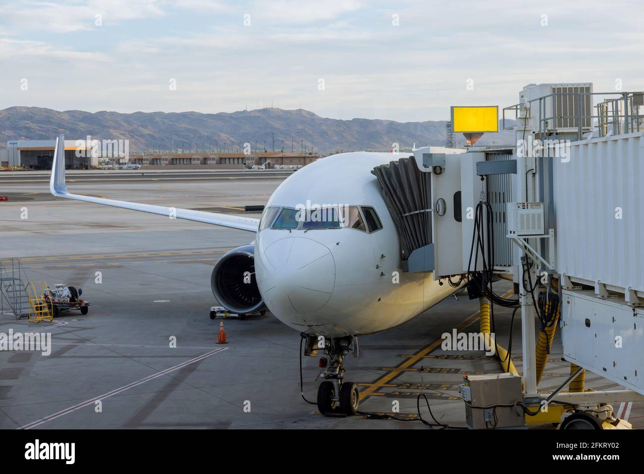 Parking at terminal gate passenger aircraft at the connected boarding ...
