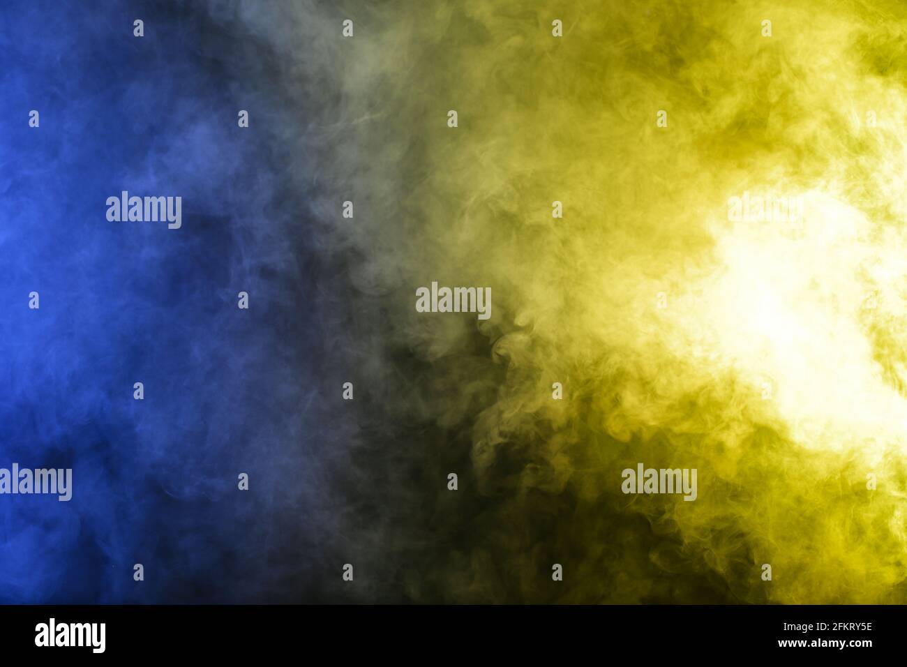 Smoke in blue yellow light on black background Stock Photo - Alamy