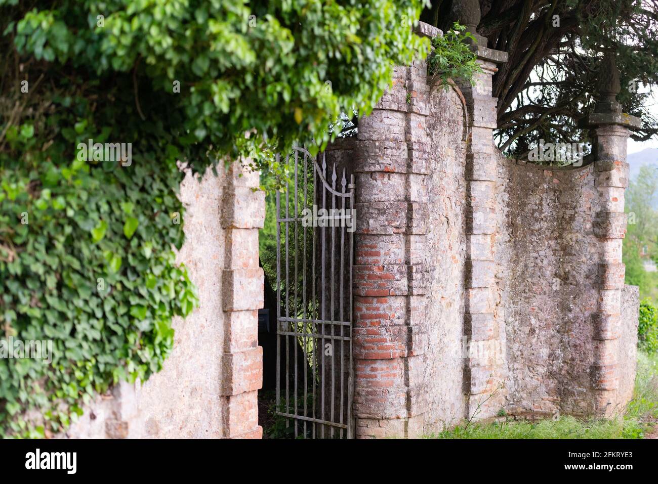 Gateway to a villa in the mountains of Italy. Old dilapidated brickwork ...