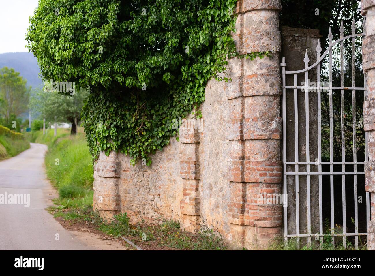Gateway to a villa in the mountains of Italy. Old dilapidated brickwork ...