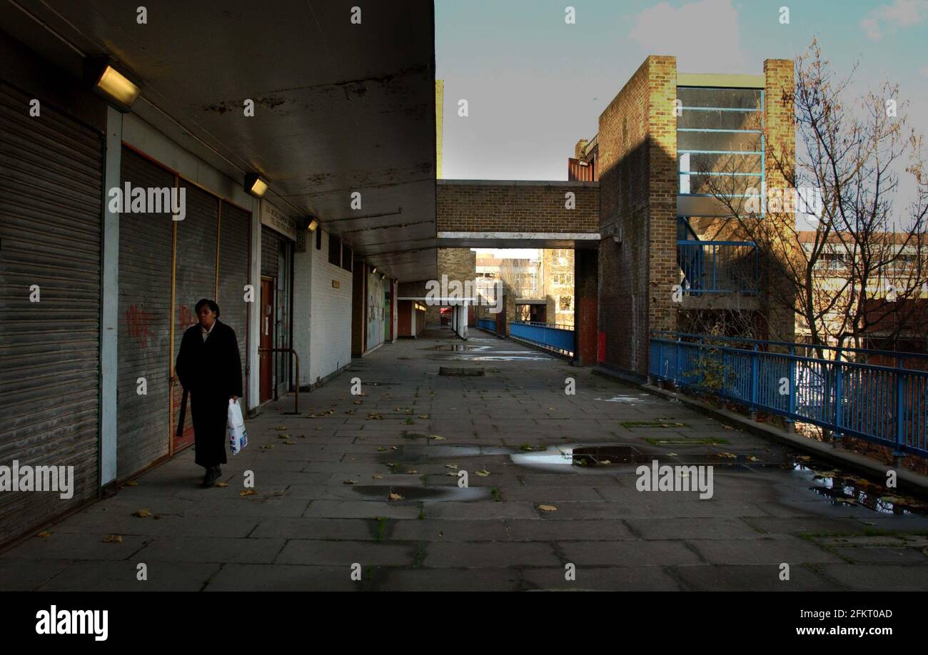 a woman walks along a walkway of the north peckham estate part of which ...