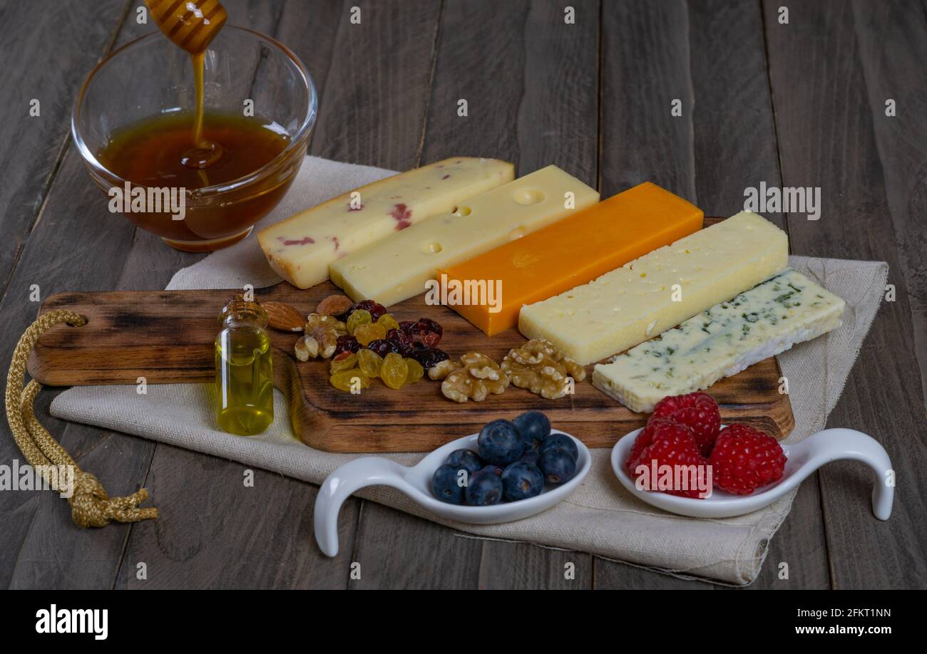 assorted cheese board with honey and nuts Stock Photo - Alamy