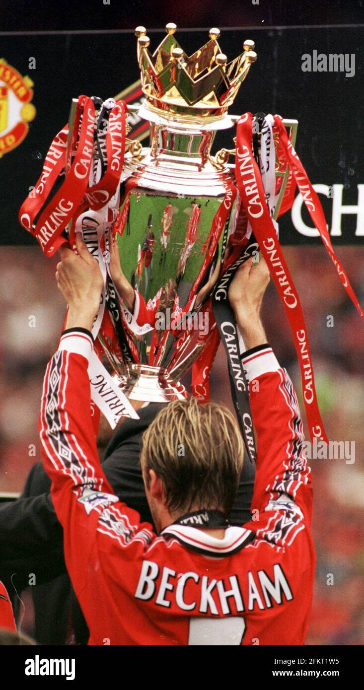 David Beckham holds up the Premiership trophy after Manchester United ...