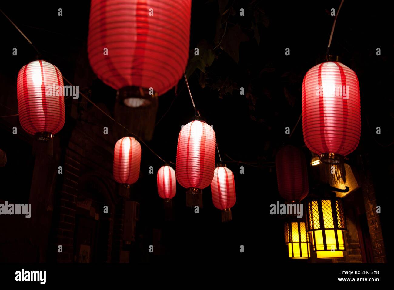 Paper lanterns on city street at night Stock Photo - Alamy