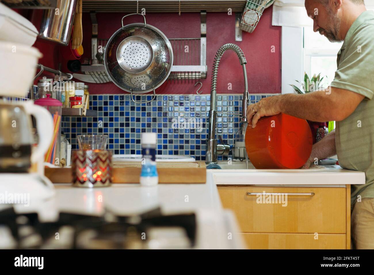 Man washing red pot Stock Photo - Alamy