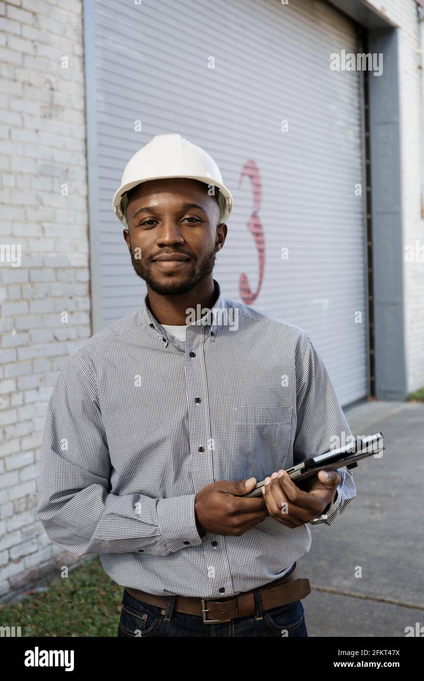 Portrait of young male architect outside building Stock Photo - Alamy