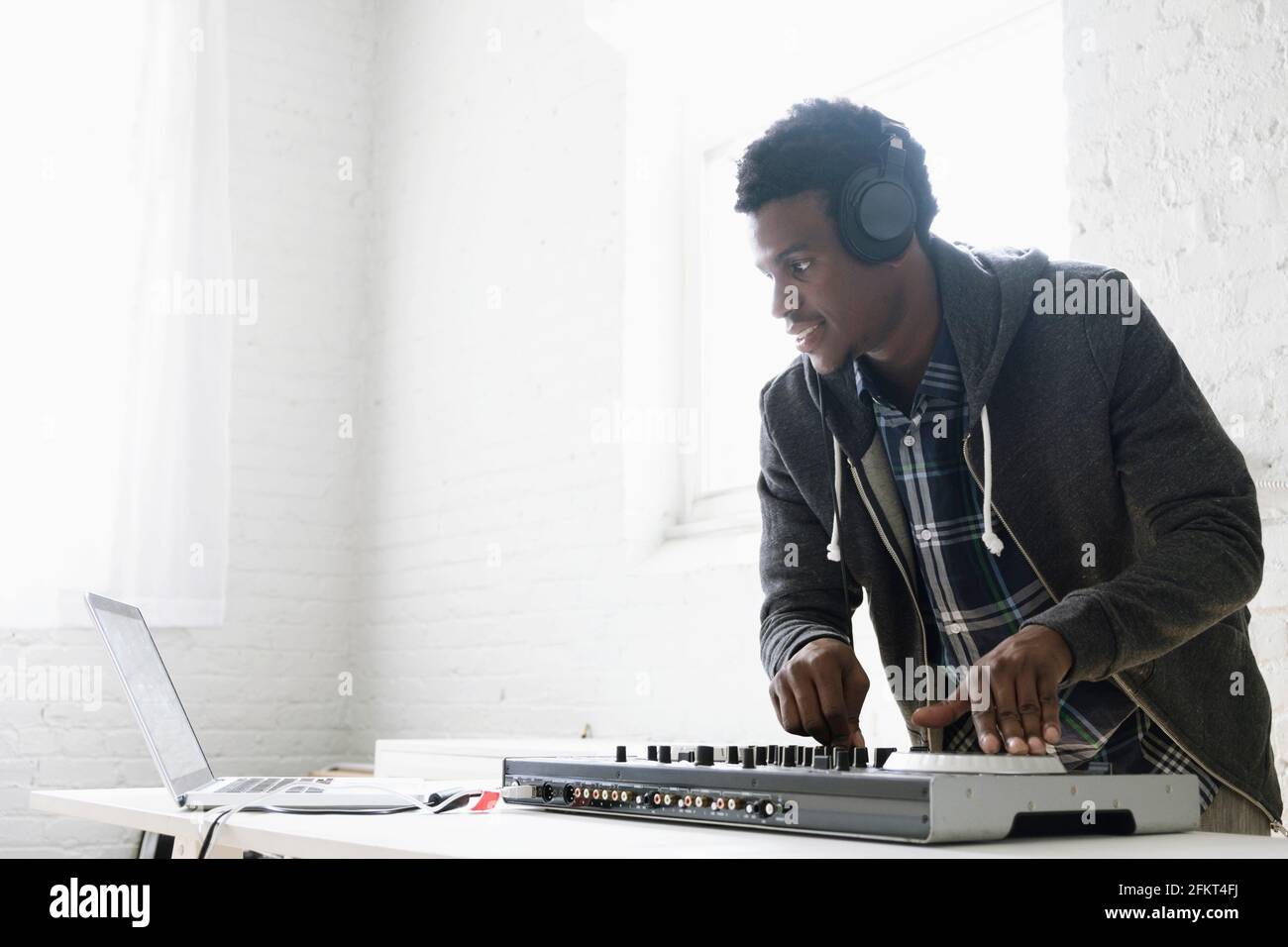 DJ using mixing desk Stock Photo - Alamy