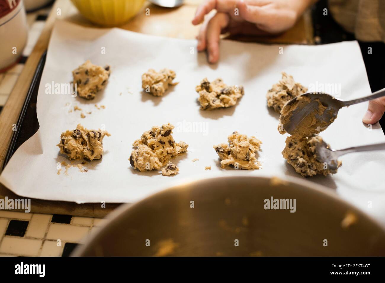 Hand of mid adult woman spooning baking mixture in kitchen Stock Photo ...