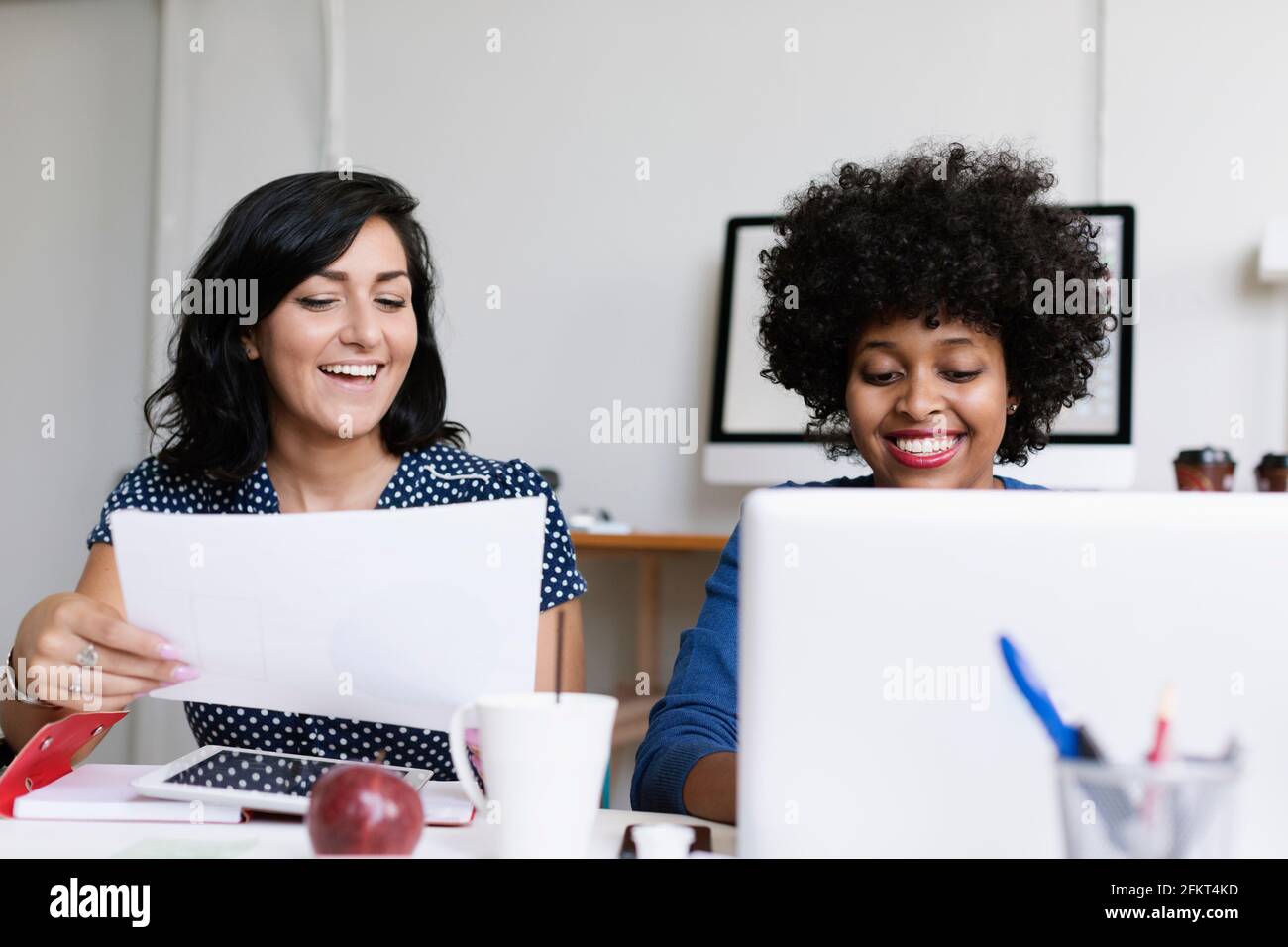 Two women working interior hi-res stock photography and images - Alamy