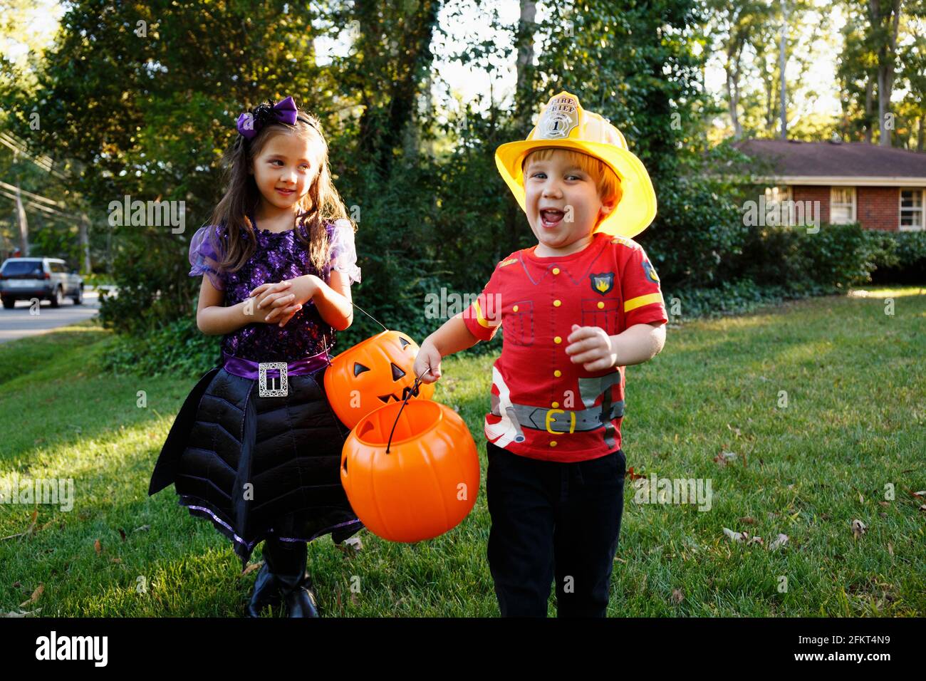Two children trick or treating Stock Photo - Alamy