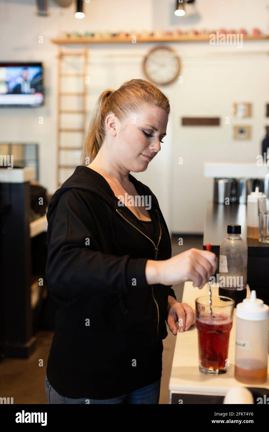 Coffee shop barista making fruit tea Stock Photo - Alamy