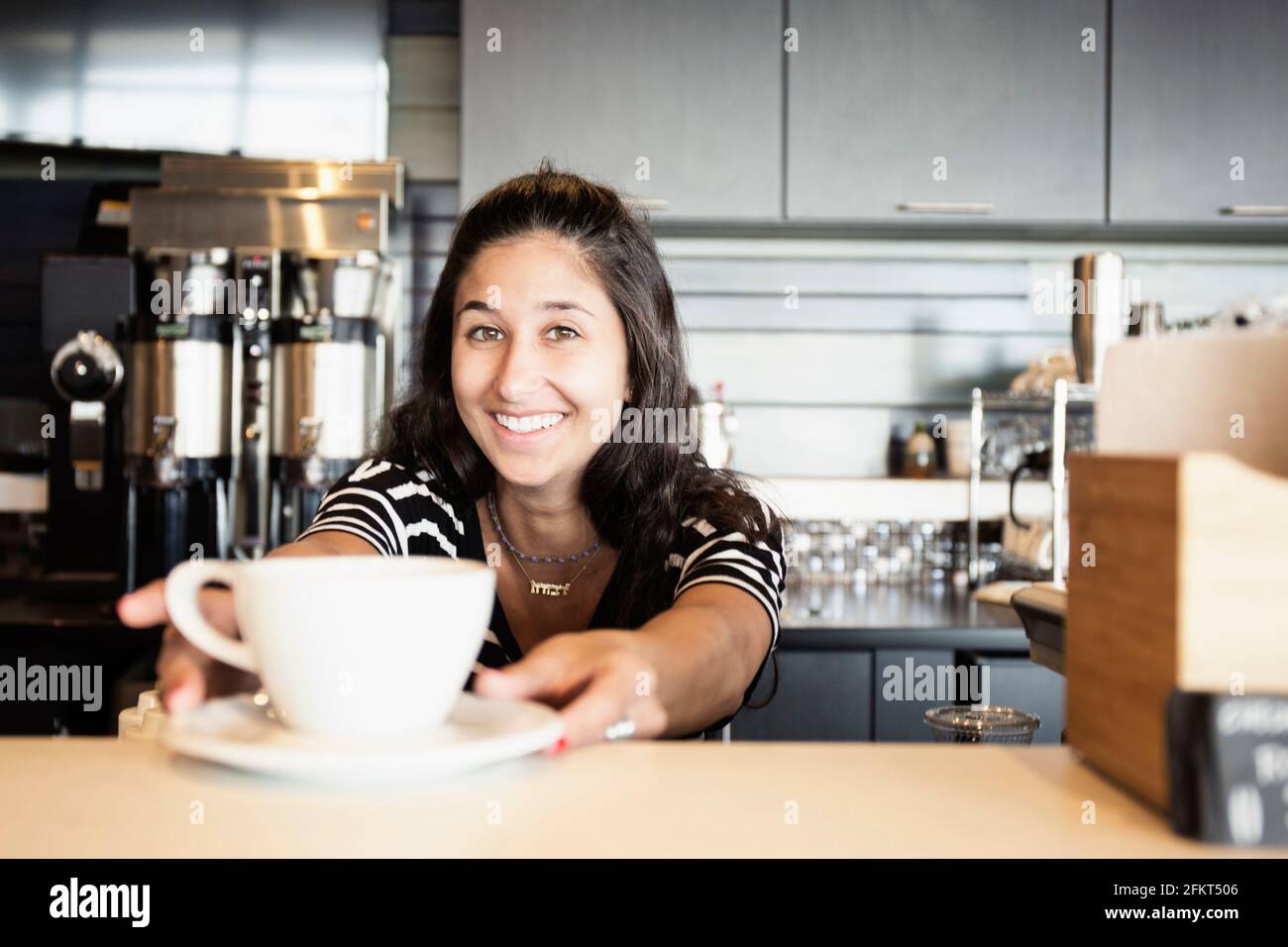 Coffee shop barista serving coffee Stock Photo - Alamy