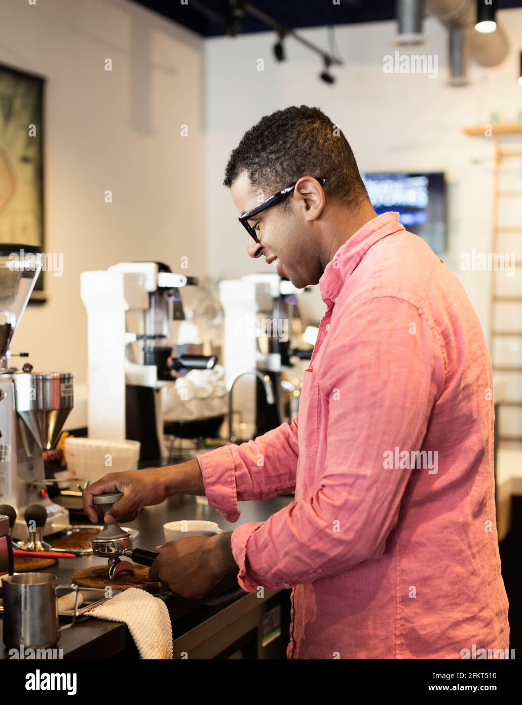 Coffee shop barista removing coffee grounds Stock Photo - Alamy