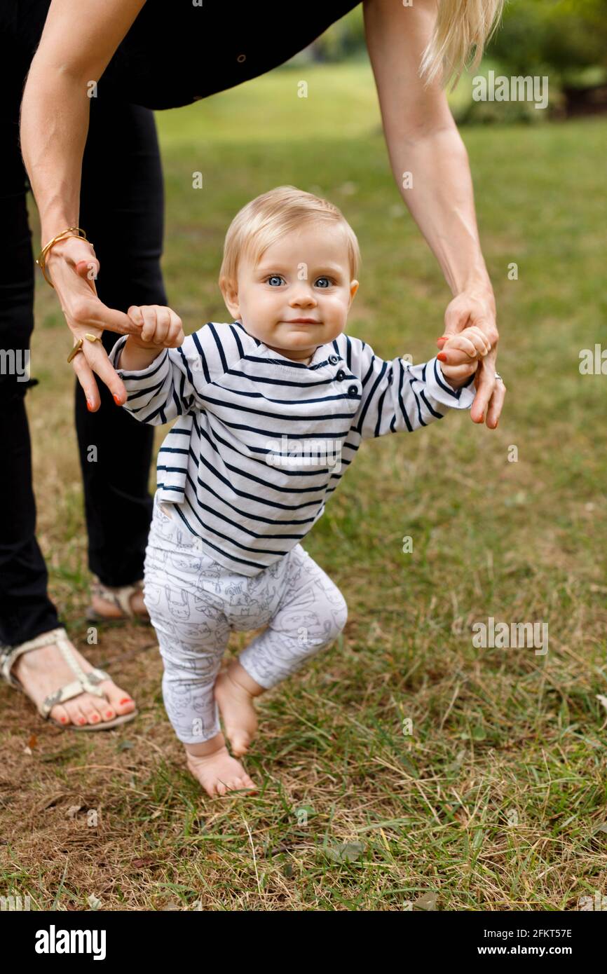 Adult help baby walk hi-res stock photography and images - Alamy