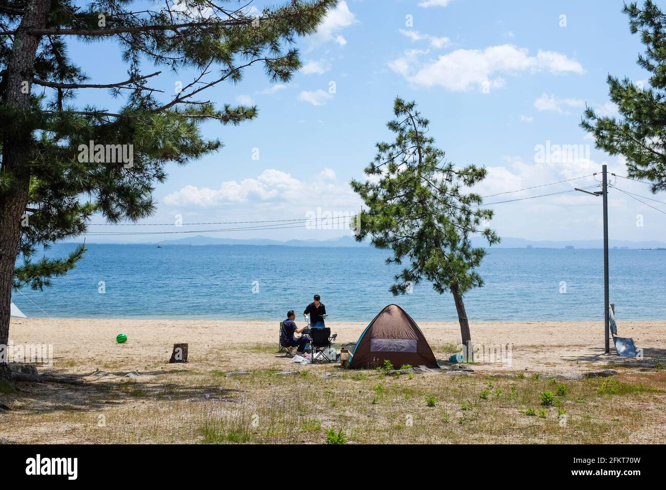 People camping on the shore of Lake Biwa (Biwako) in Shiga Prefecture ...
