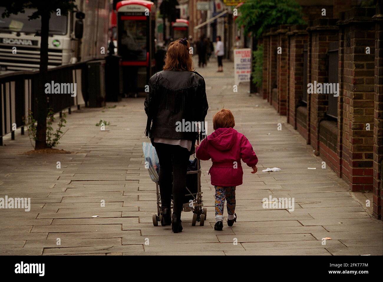 Single Mother pushing Pram and Child July 1997walking down street Stock ...