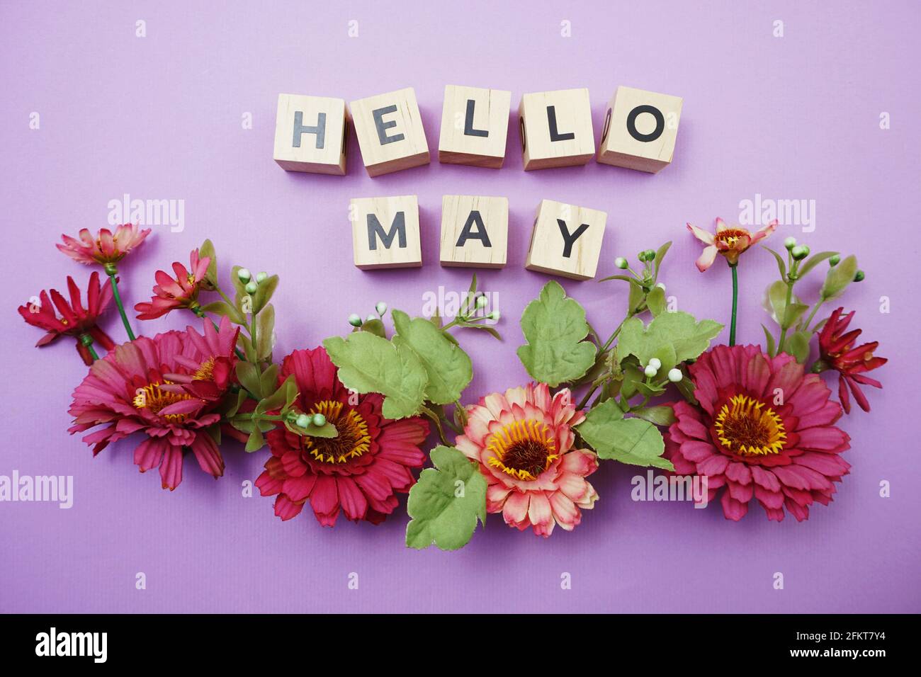 Hello May alphabet letters with flower decoration top view on purple ...