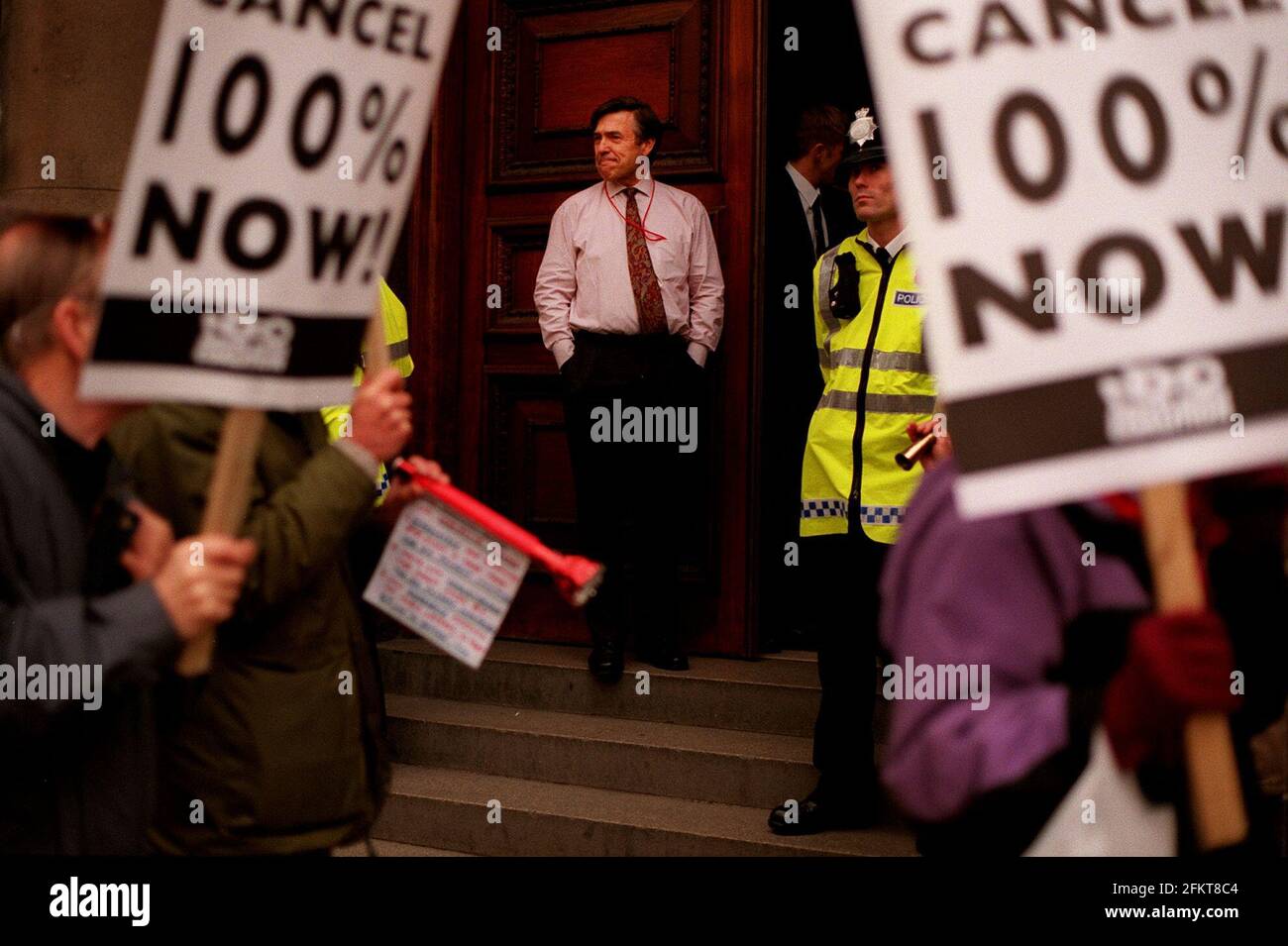 A treasury employee watches on from the steps as protesters make a ...