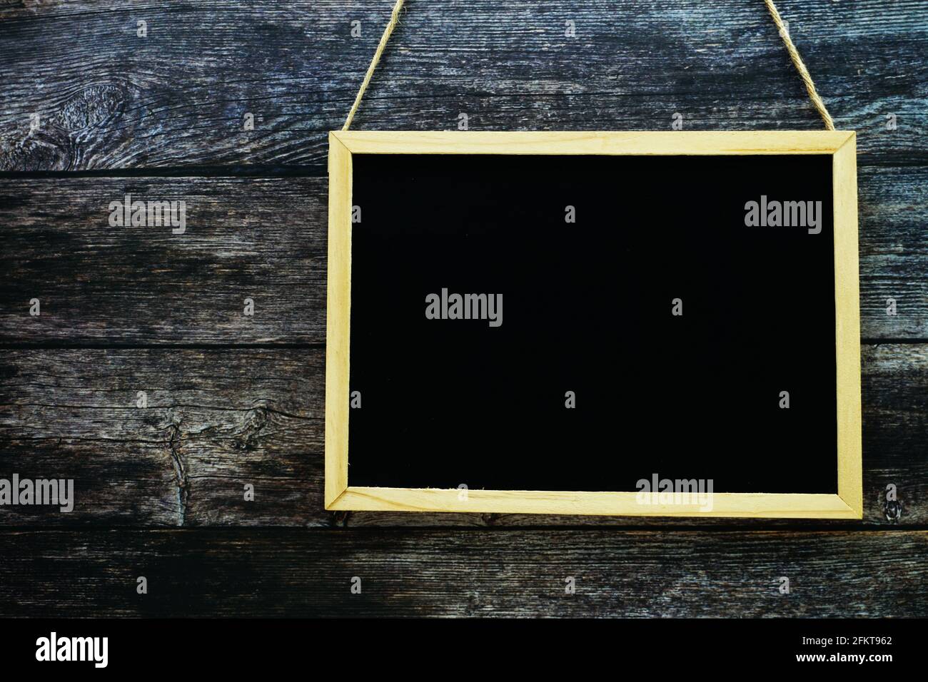 Empty black board on dark wooden wall texture background Stock Photo ...