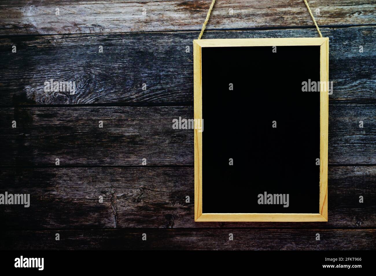 Empty black board on dark wooden wall texture background Stock Photo ...