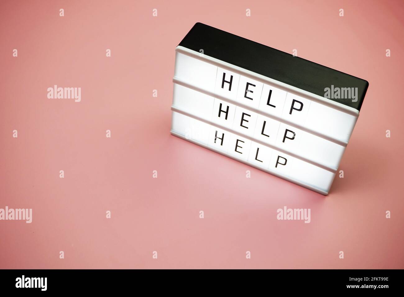 Help word text in light box on pink background Stock Photo - Alamy