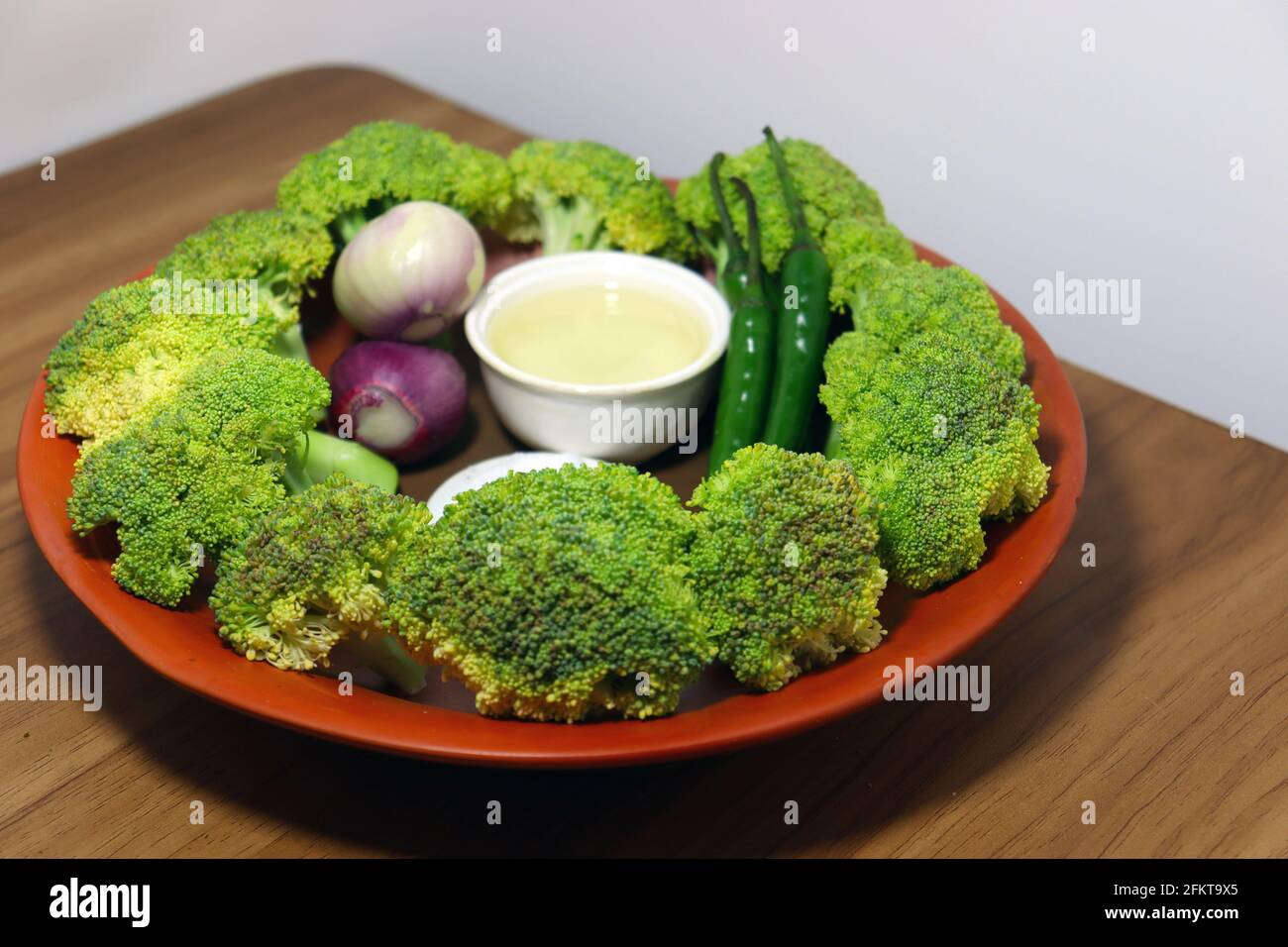 tasty and healthy sliced broccoli with spices stock on plate Stock ...