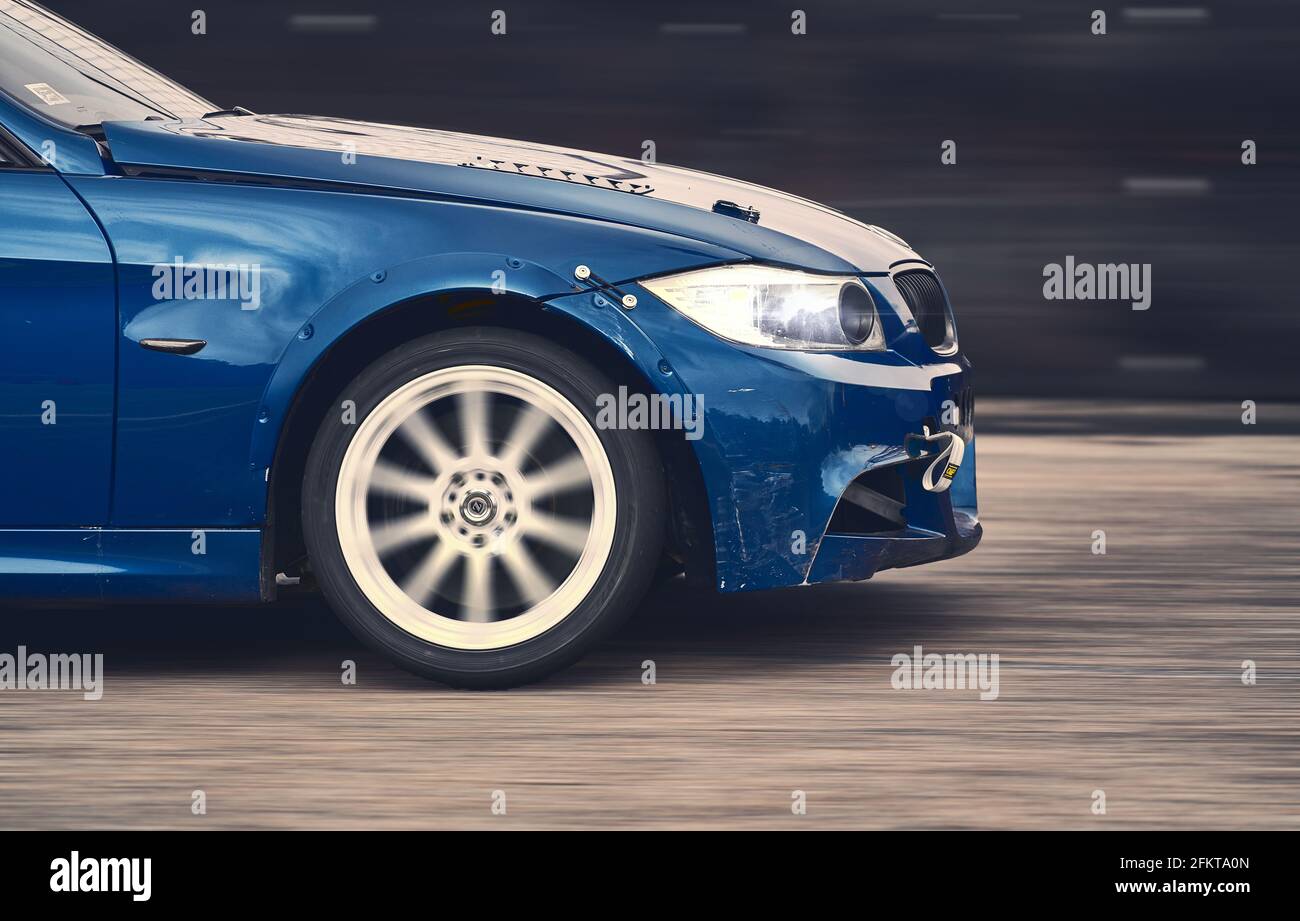 Front side view of black car driving fast Stock Photo - Alamy