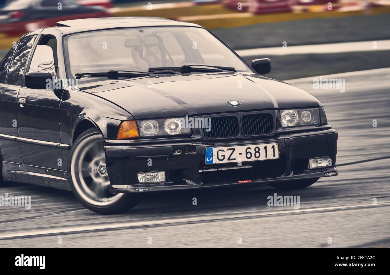 Front side view of black car driving fast Stock Photo - Alamy