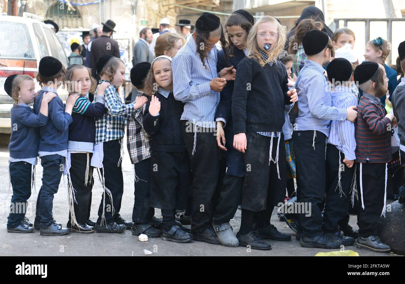 Jewish Orthodox children waiting in line for food and sweets served by ...