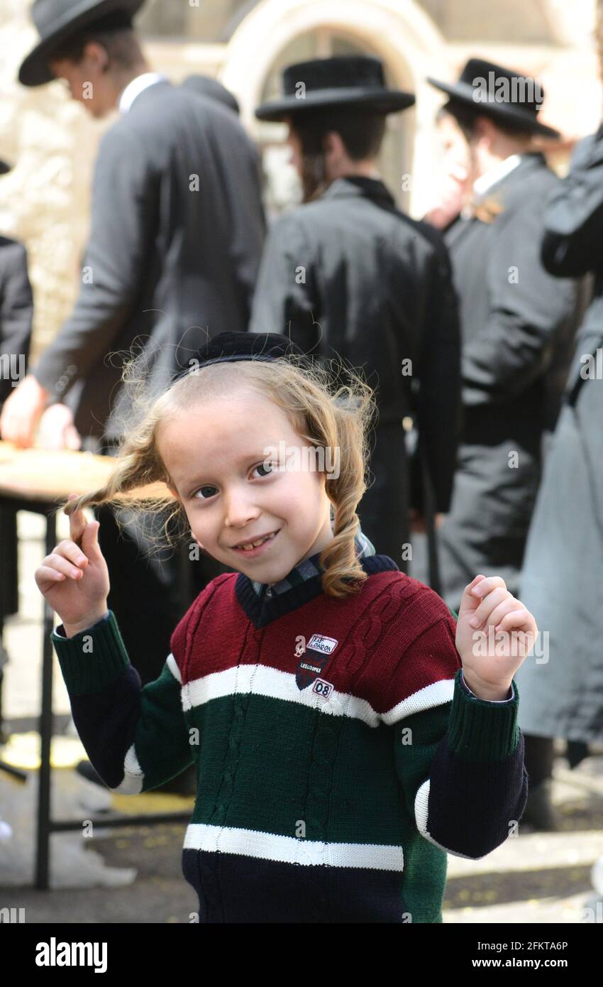 Jewish Orthodox children waiting in line for food and sweets served by ...