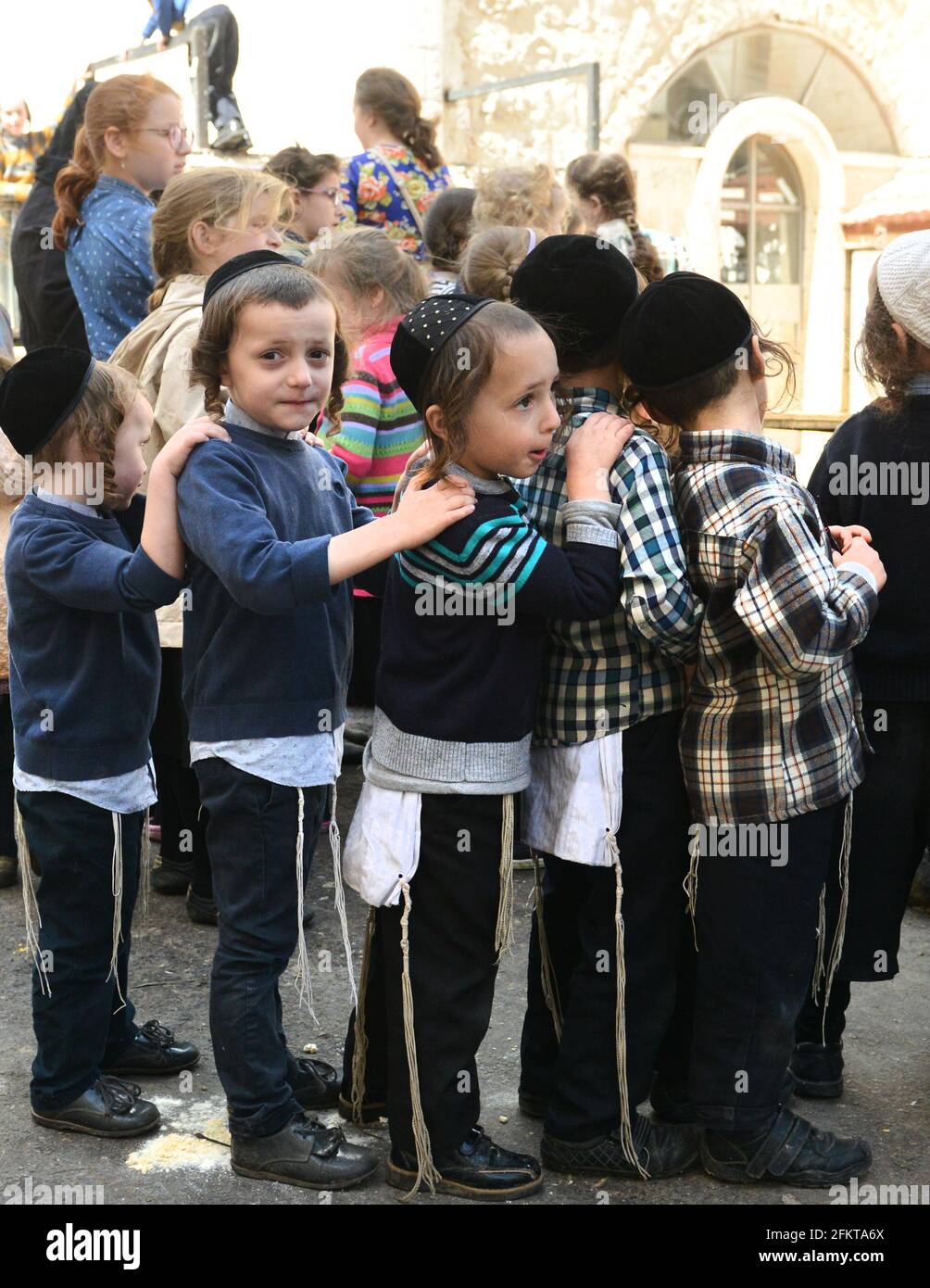 Jewish Orthodox children waiting in line for food and sweets served by ...