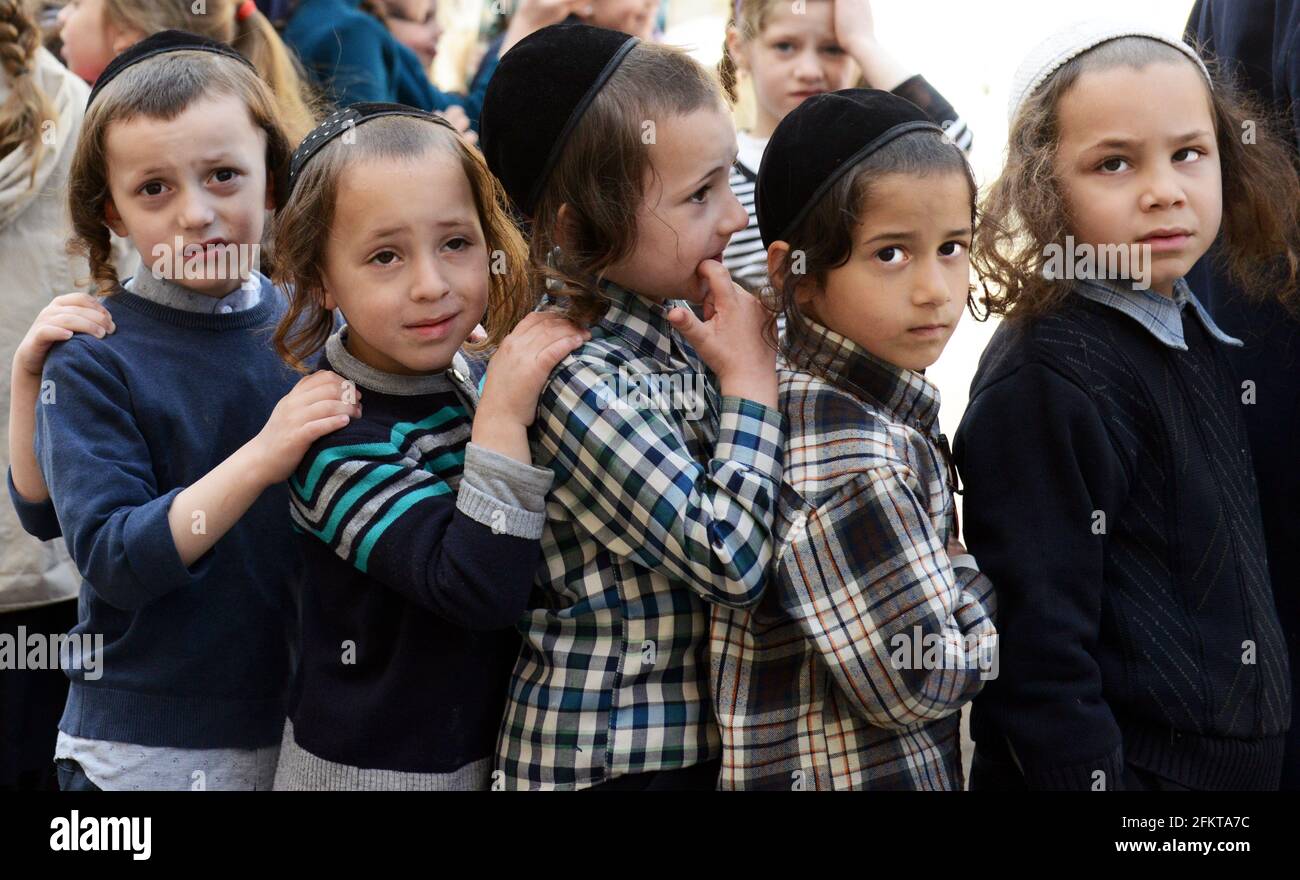 Jewish Orthodox children waiting in line for food and sweets served by ...