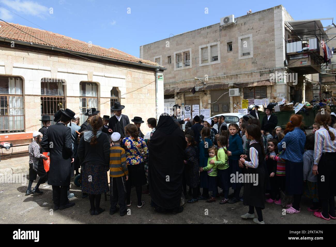 Jewish Orthodox children waiting in line for food and sweets served by ...