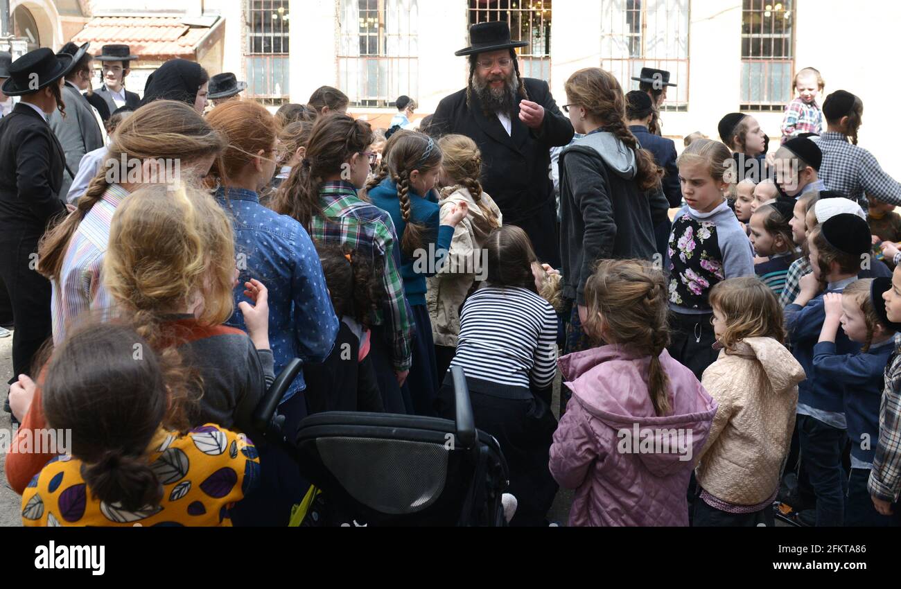 Jewish Orthodox children waiting in line for food and sweets served by ...
