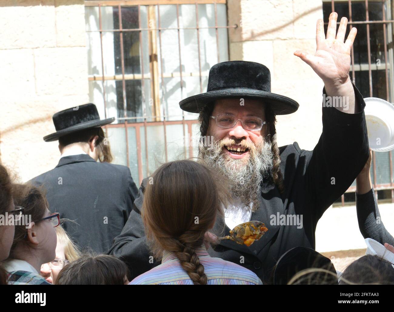 Jewish Orthodox children waiting in line for food and sweets served by ...
