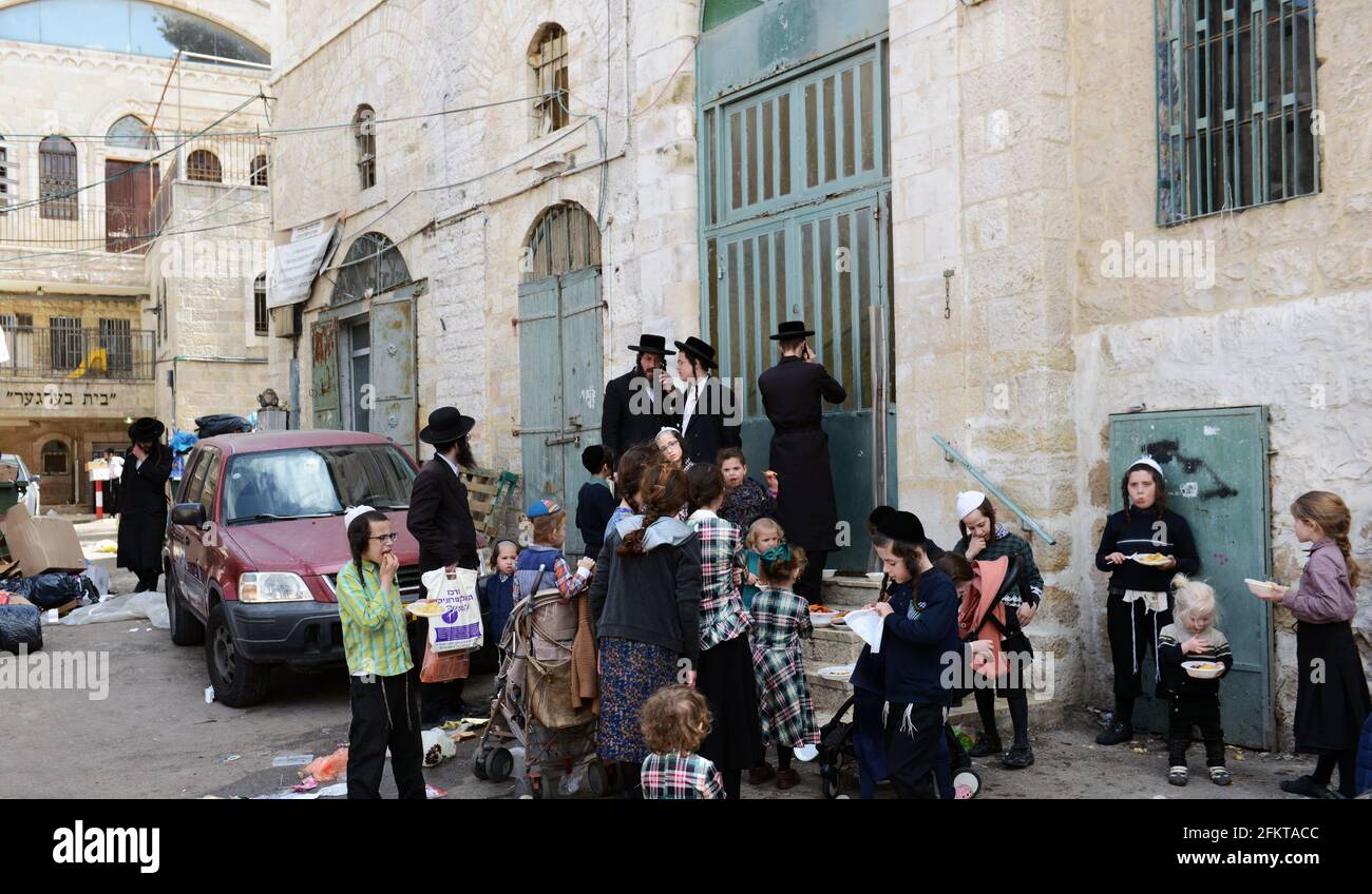 Jewish Orthodox children waiting in line for food and sweets served by ...