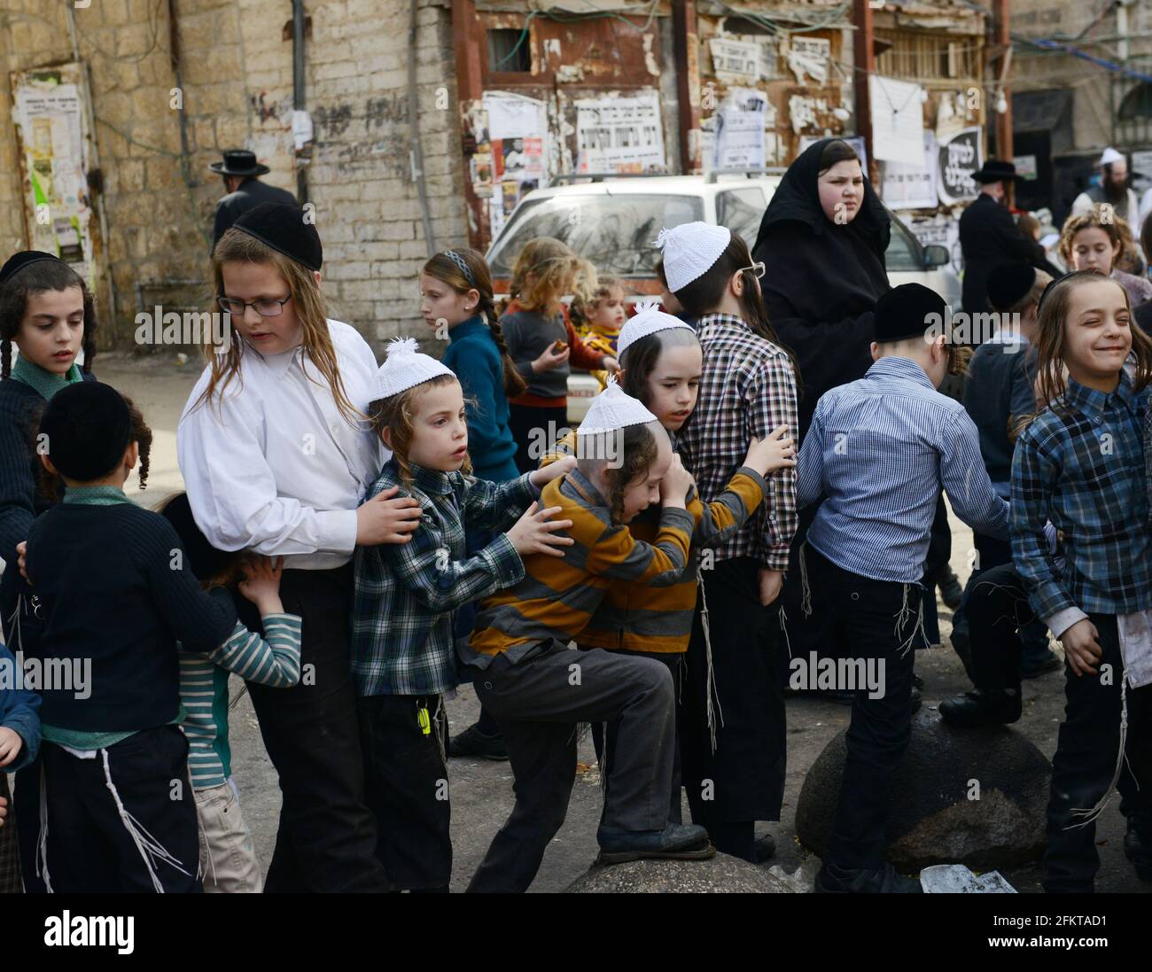 Jewish Orthodox children waiting in line for food and sweets served by ...