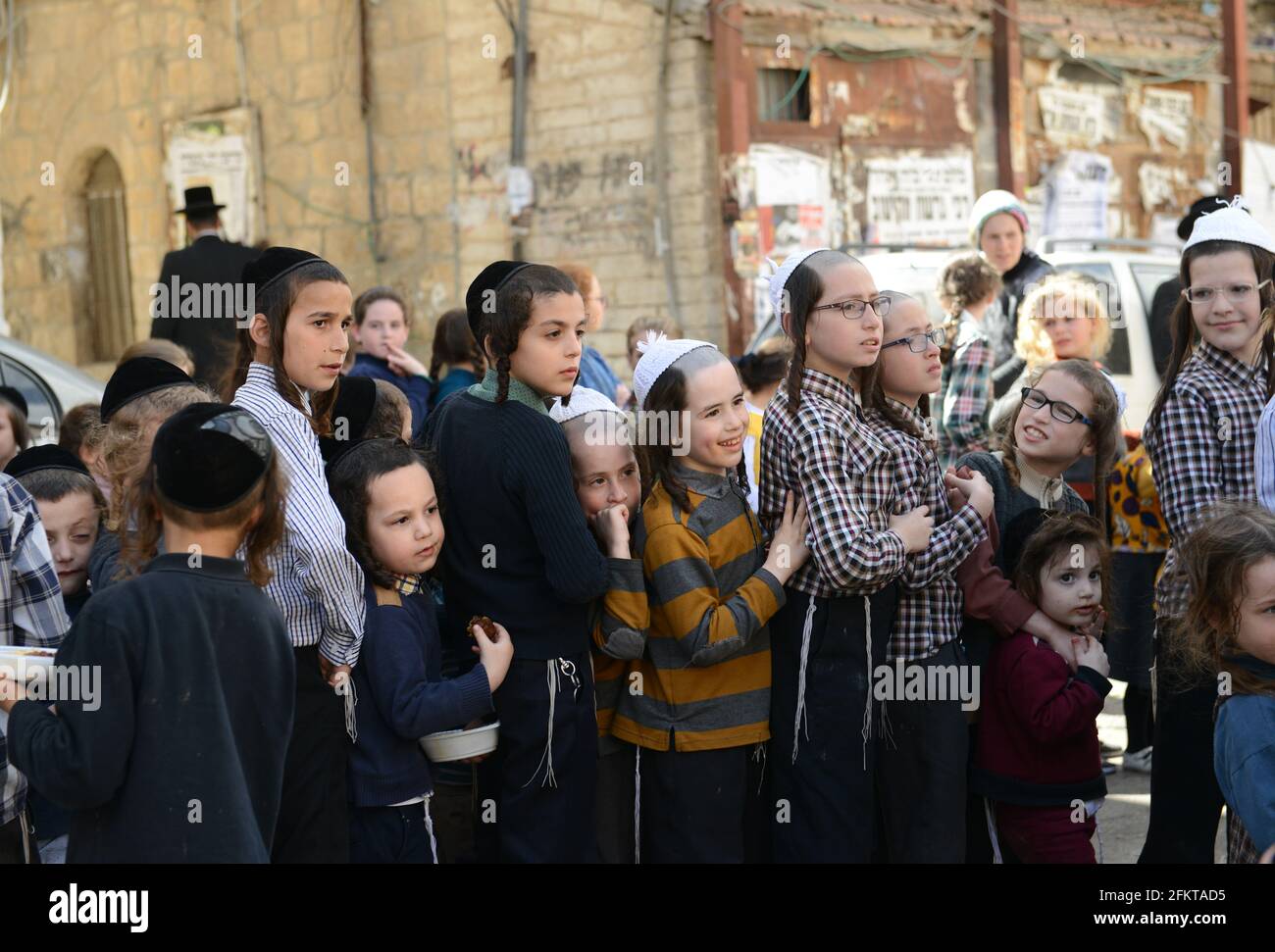 Jewish Orthodox children waiting in line for food and sweets served by ...