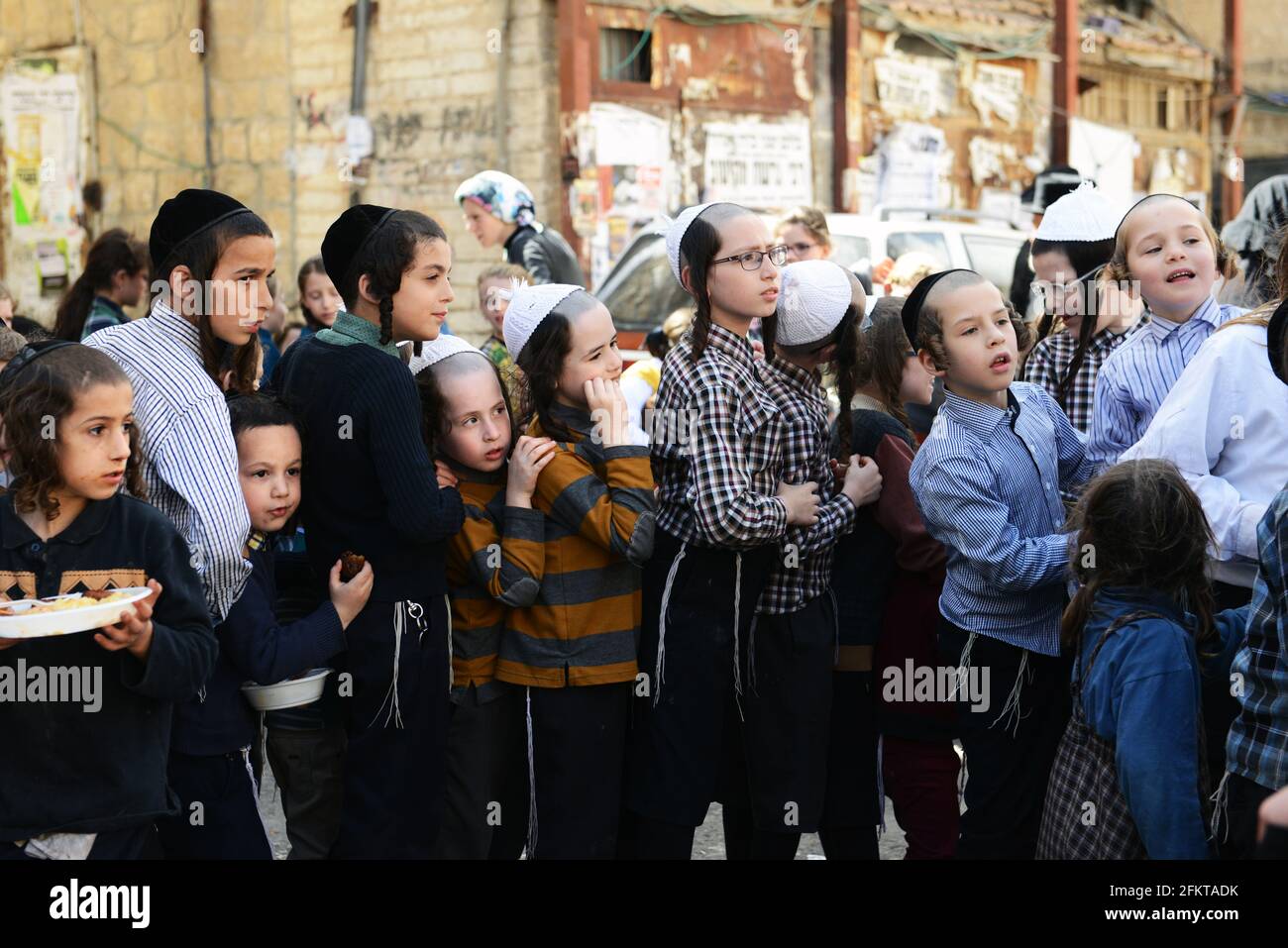 Jewish Orthodox children waiting in line for food and sweets served by ...