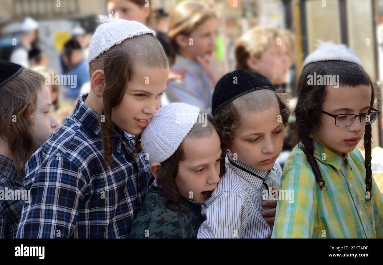 Jewish Orthodox children waiting in line for food and sweets served by ...