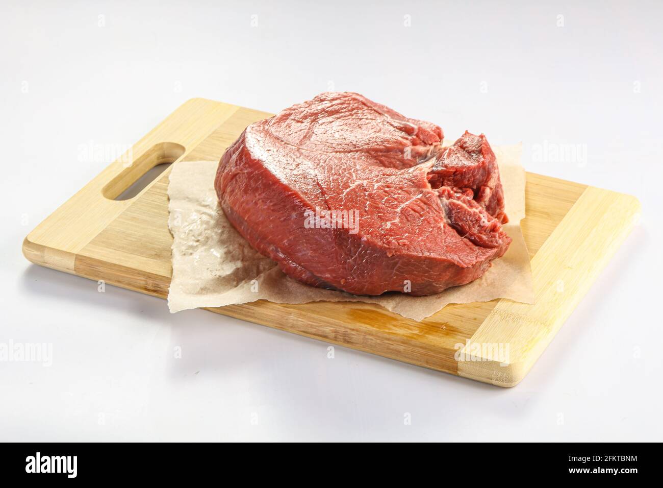Raw beef meat over board isolated Stock Photo - Alamy