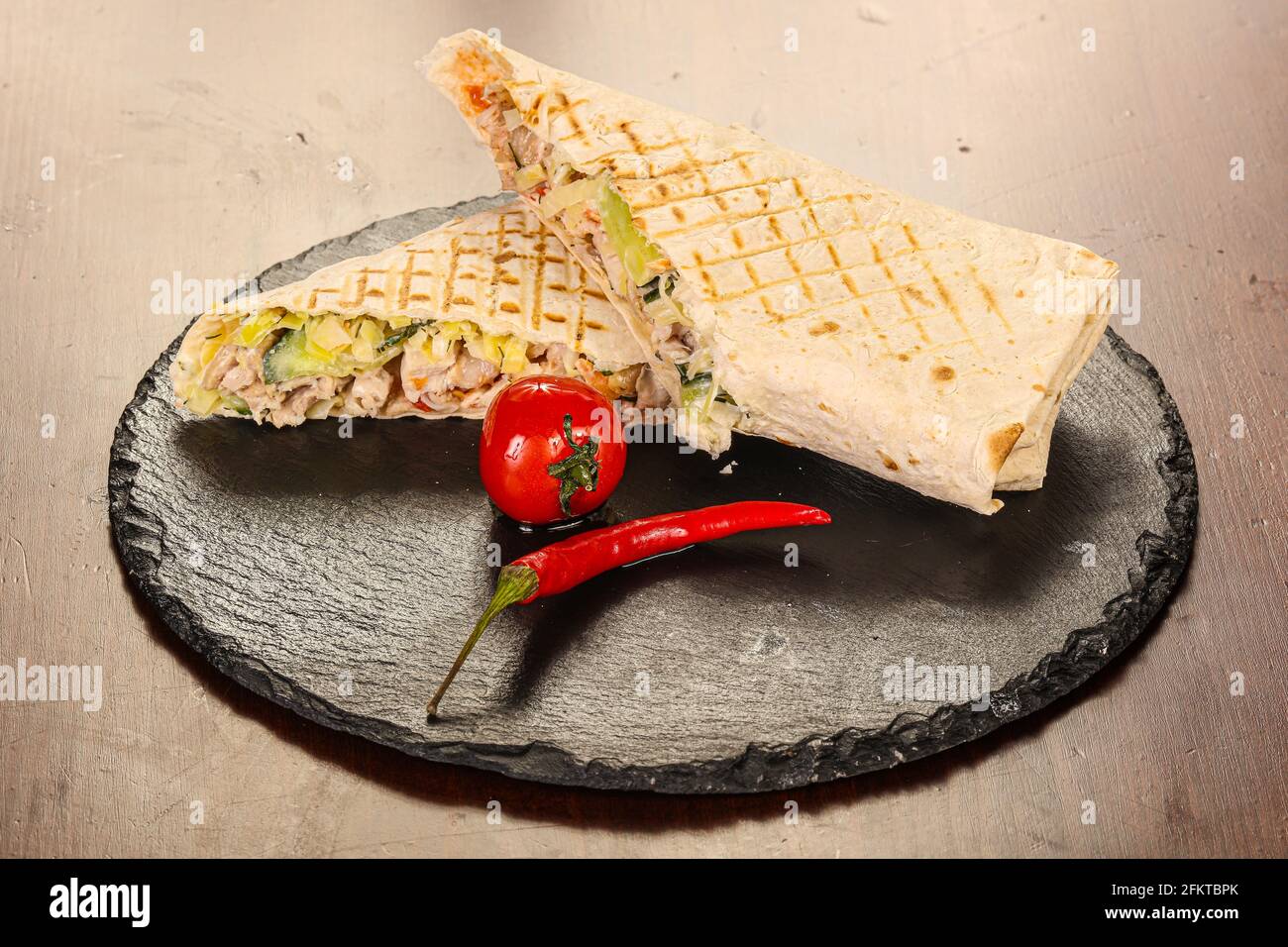 Tasty shawarma with meat, sauce and vegetables Stock Photo - Alamy