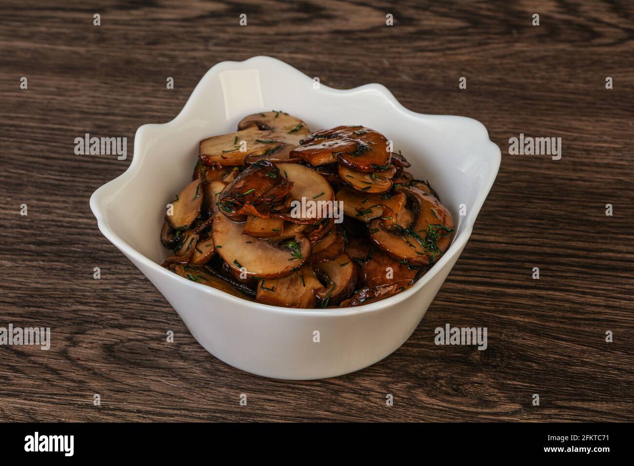 Roasted champignon with herbs and spices in the bowl Stock Photo - Alamy